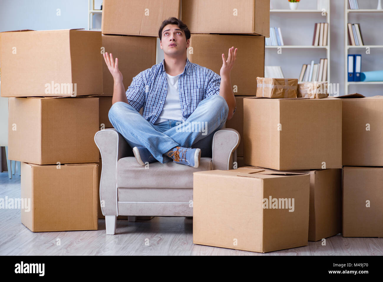 Young man moving in to new house with boxes Stock Photo - Alamy
