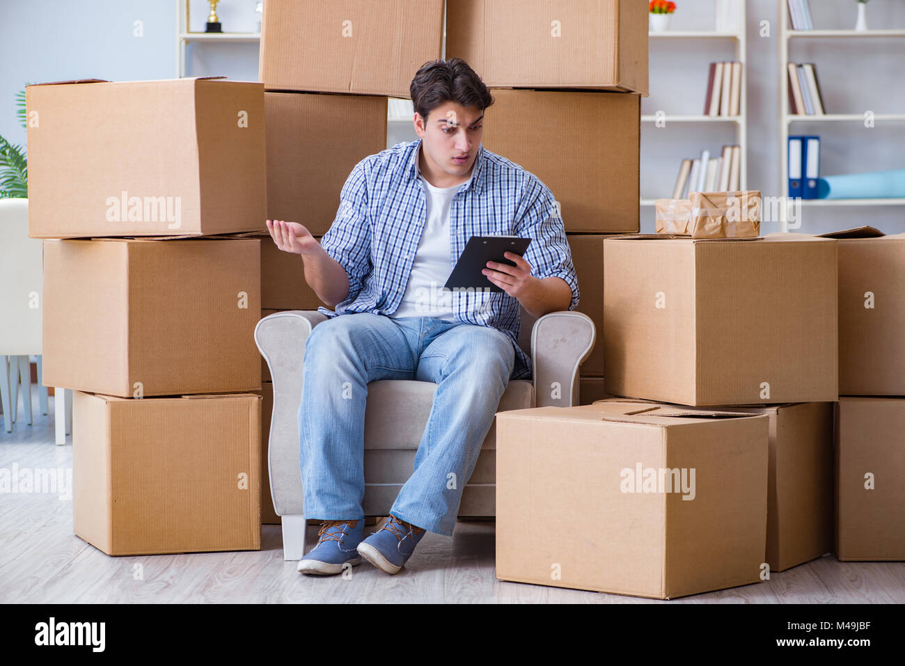 Young man moving in to new house with boxes Stock Photo - Alamy