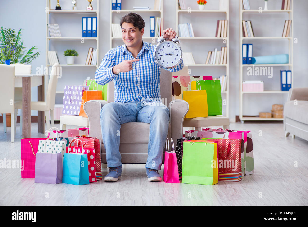 Young man after excessive shopping at home Stock Photo - Alamy
