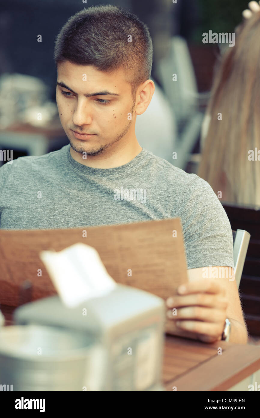 Guy looking at menu hi-res stock photography and images - Alamy
