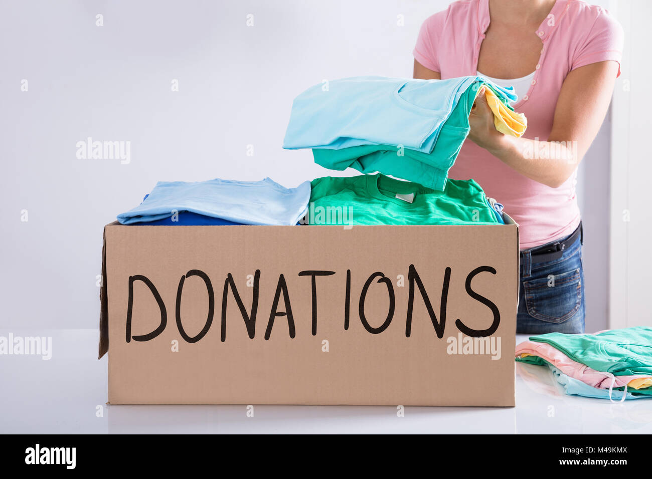 Woman packing box clothes hi-res stock photography and images - Alamy