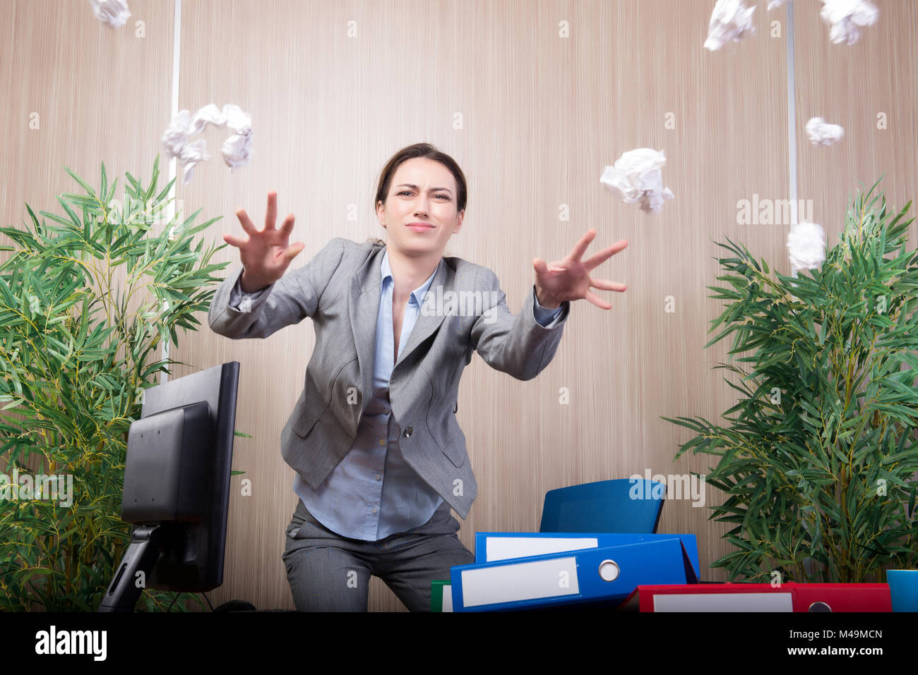 The woman under stress tossing papers in the office Stock Photo - Alamy