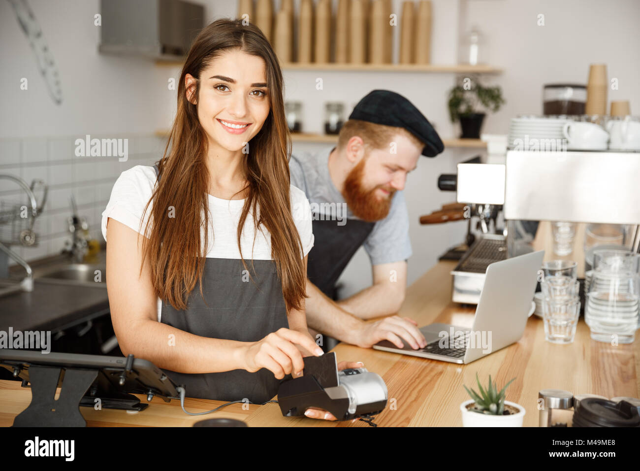 Coffee Business Concept - Beautiful female barista giving payment ...