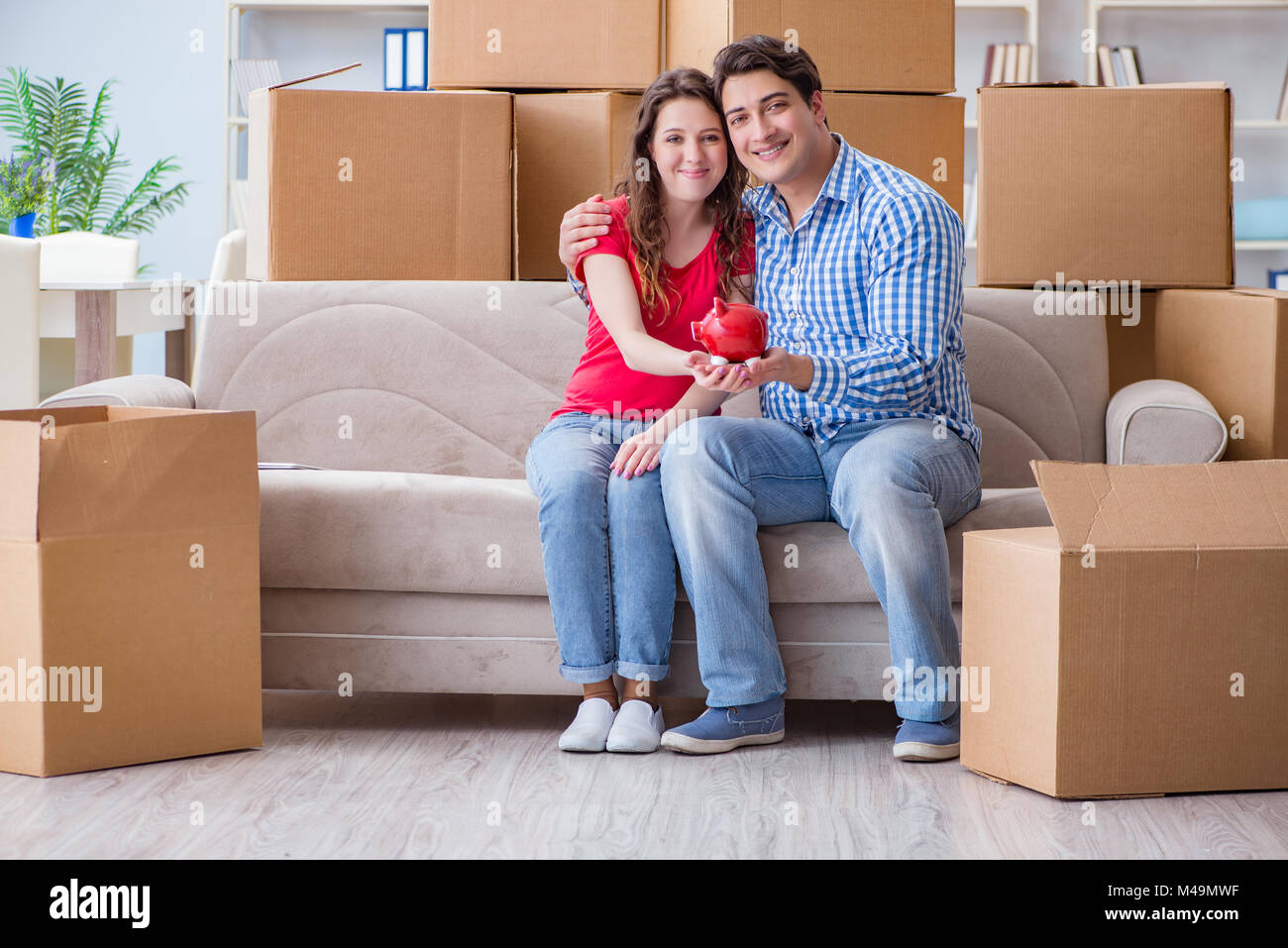 Young pair moving in to new house with boxes Stock Photo - Alamy