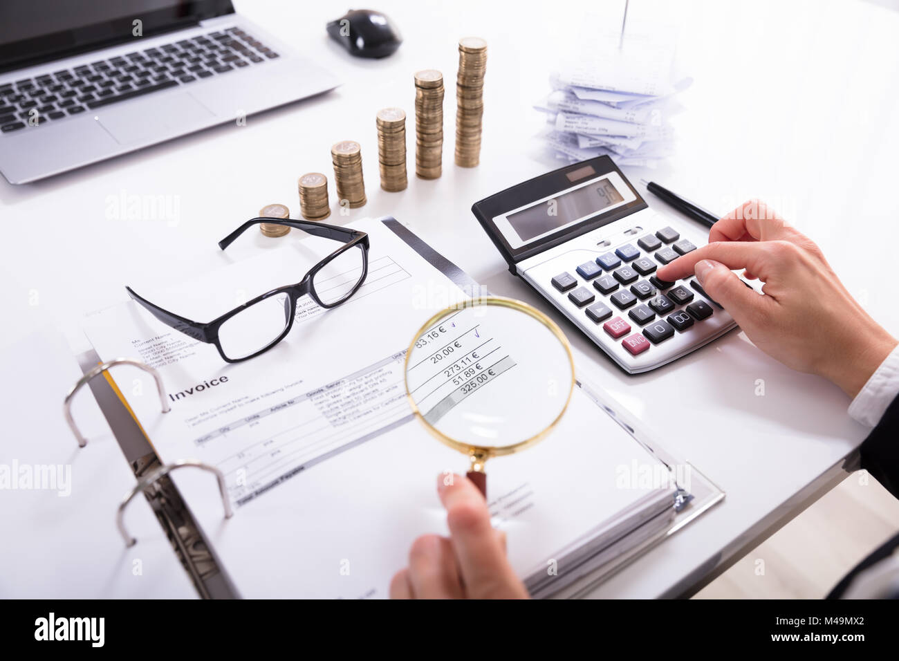 Close-up Of Businesswoman Checking Invoice With Magnifying Glass At ...
