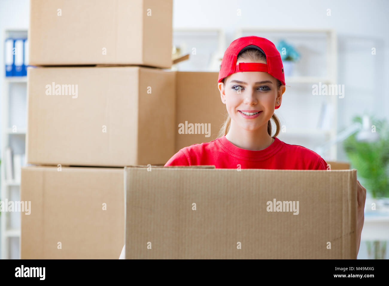 Young woman delivering boxes of personal effects Stock Photo - Alamy