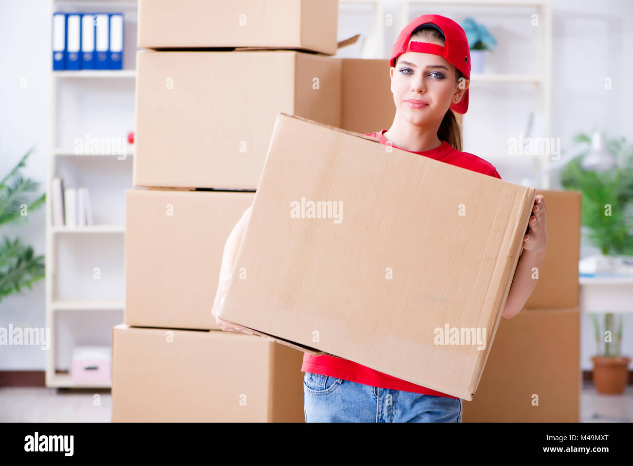 Young woman delivering boxes of personal effects Stock Photo - Alamy