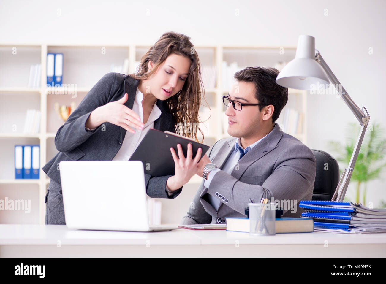 Unhappy boss having a chat with his secretary Stock Photo - Alamy