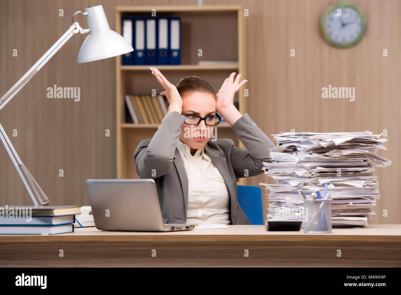 Businesswoman under stress from too much work in the office Stock Photo ...