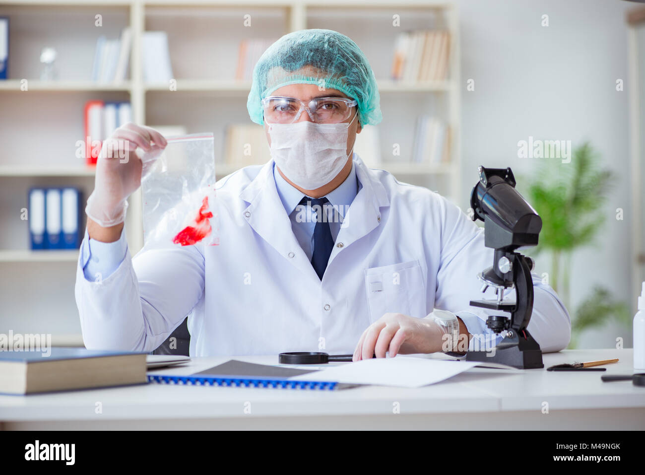 Forensics investigator working in lab on crime evidence Stock Photo - Alamy