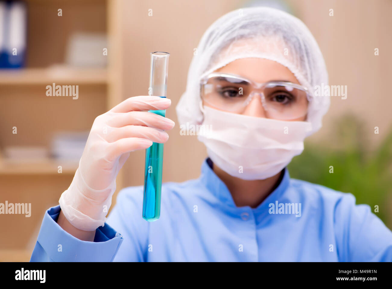 Lab chemist working with microscope and tubes Stock Photo - Alamy