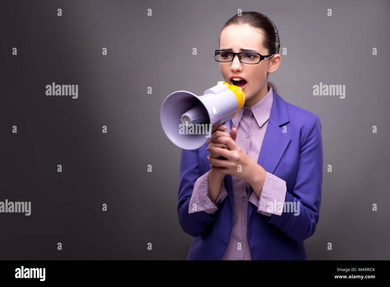 Young businesswoman yelling through loudspeaker Stock Photo - Alamy