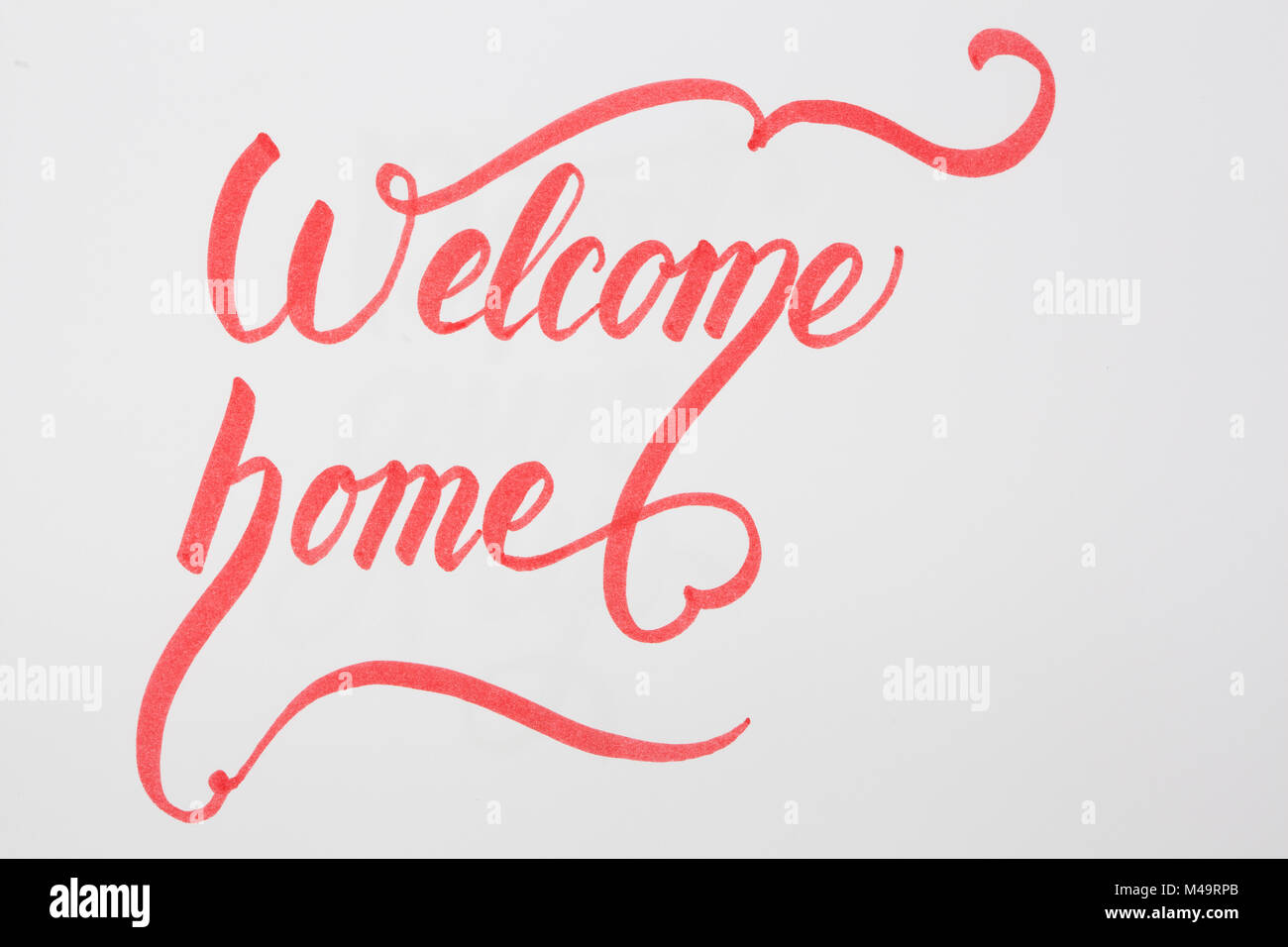 Welcome Home creative brush lettering on white background with copy ...