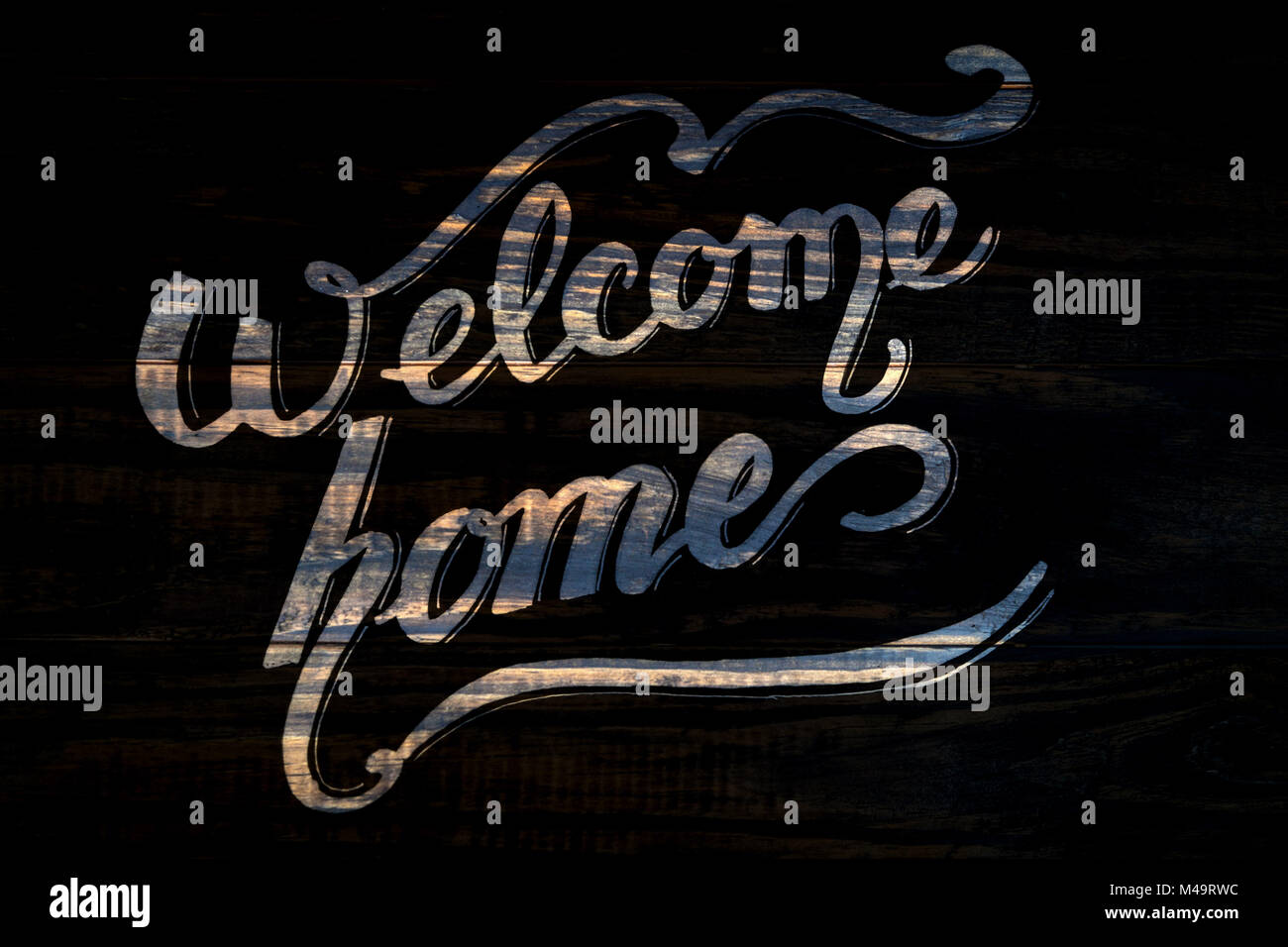 Welcome Home wooden calligraphy lettering on black Stock Photo - Alamy