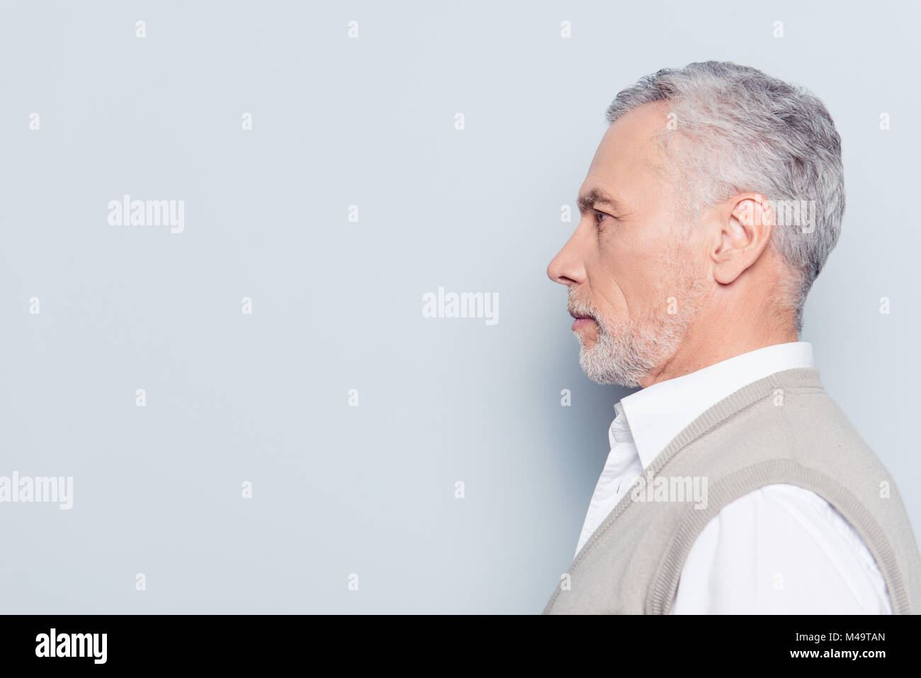 Side profile half-faced portrait of pensive thoughtful serious ...