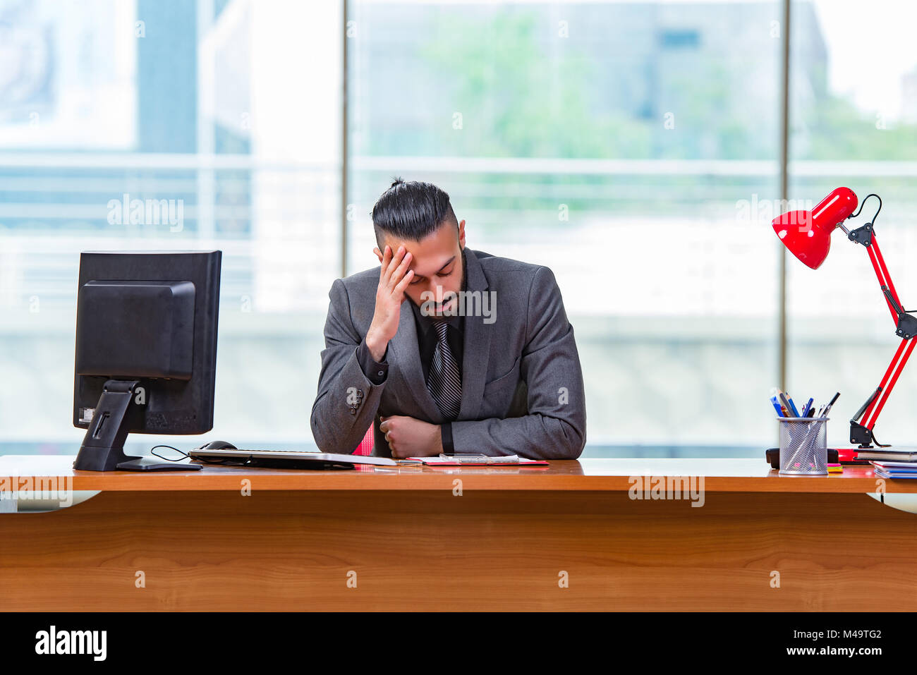 Sad businessman sitting in the office Stock Photo - Alamy