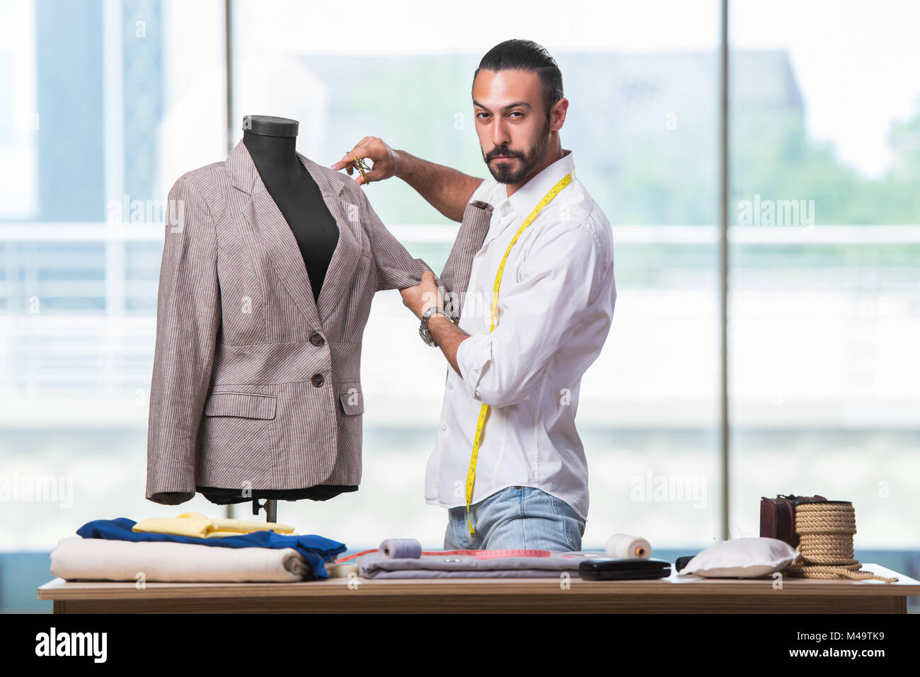 Young tailor working on new clothing design Stock Photo - Alamy