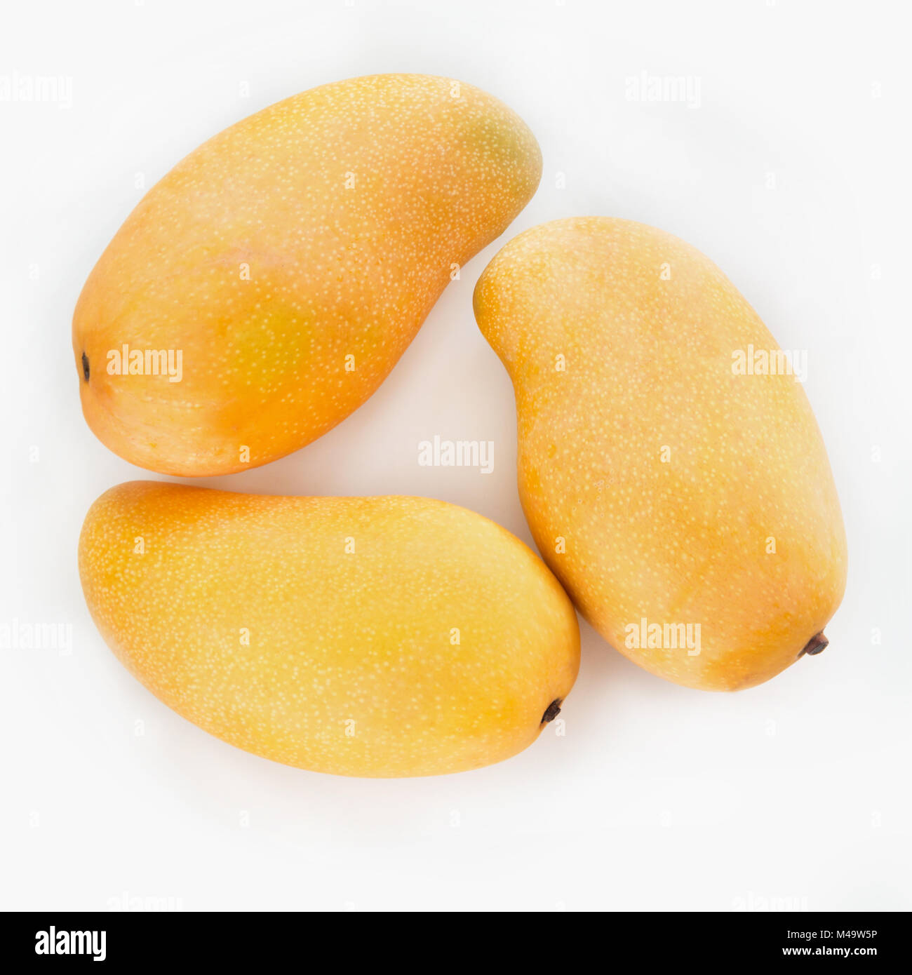 Fresh three mango fruit on white background. Top view Stock Photo - Alamy