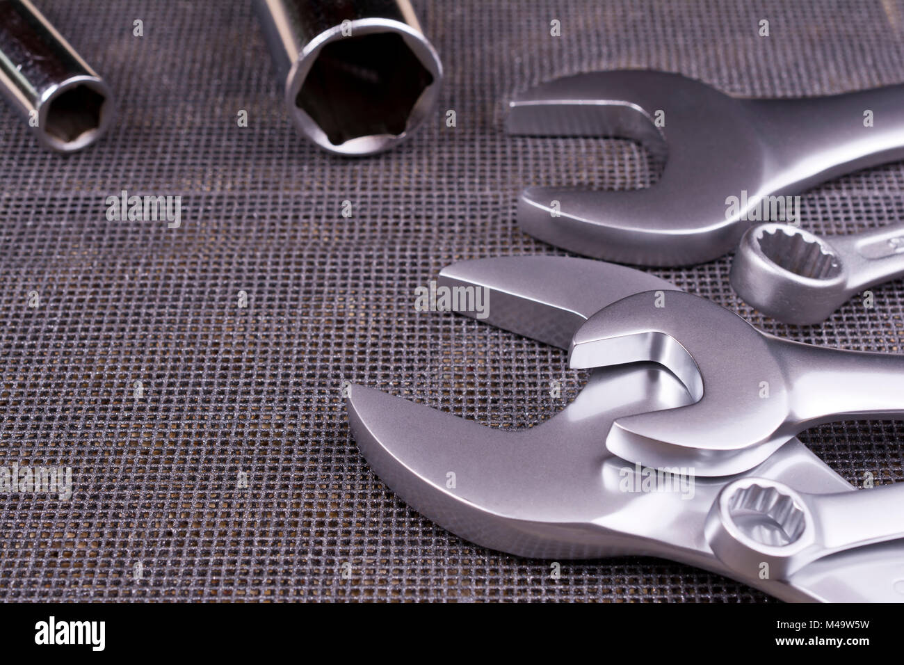 Set of wrenches on a metal background Stock Photo - Alamy