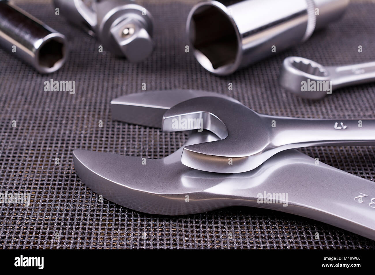 Set of wrenches on a metal background Stock Photo - Alamy