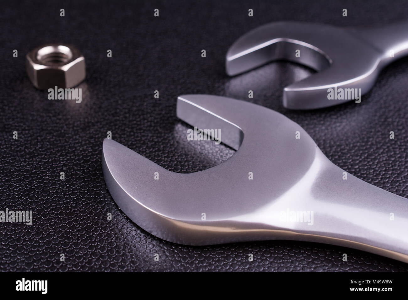 Spanners of various sizes, on dark abstract background Stock Photo - Alamy