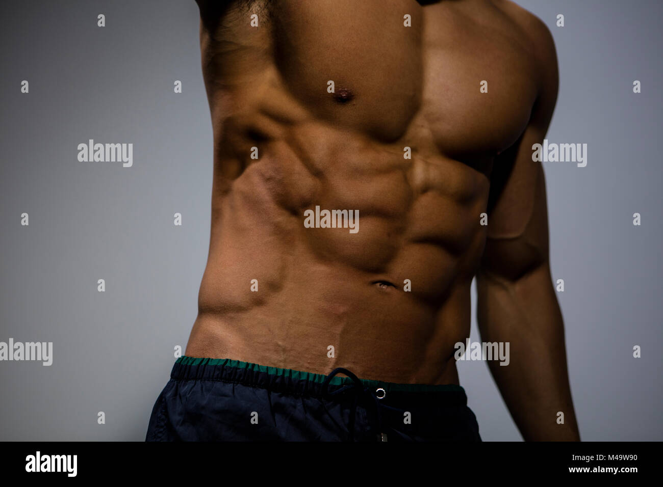 The muscular torso of a fitness model. Front facing Stock Photo - Alamy