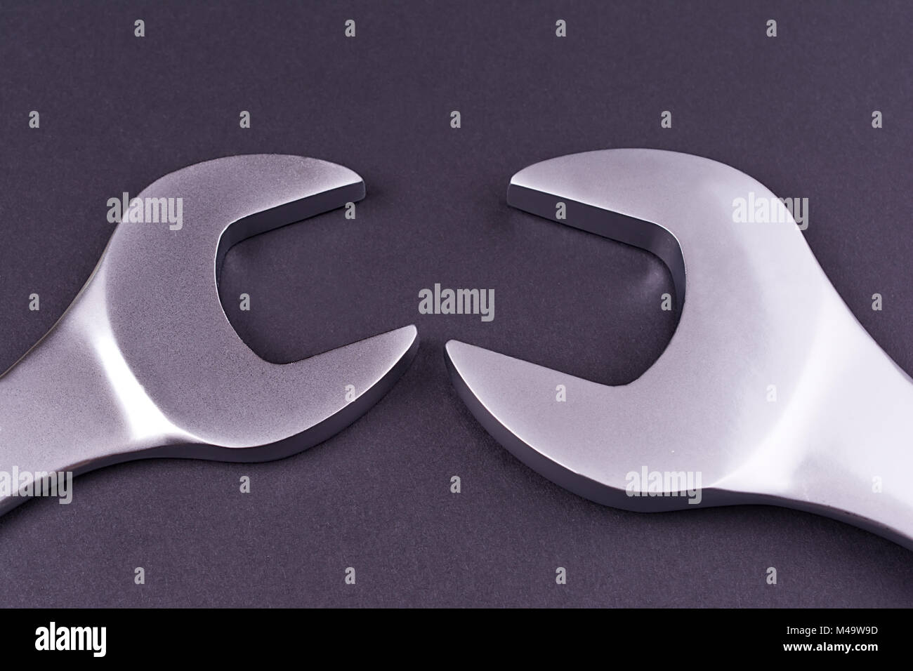 Spanners of various sizes, on dark abstract background Stock Photo - Alamy