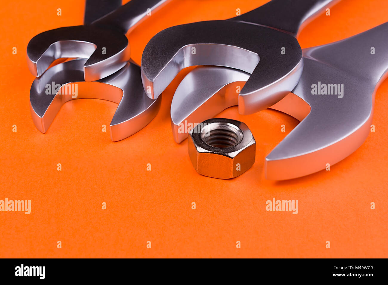 Spanners of various sizes, on orange background Stock Photo - Alamy
