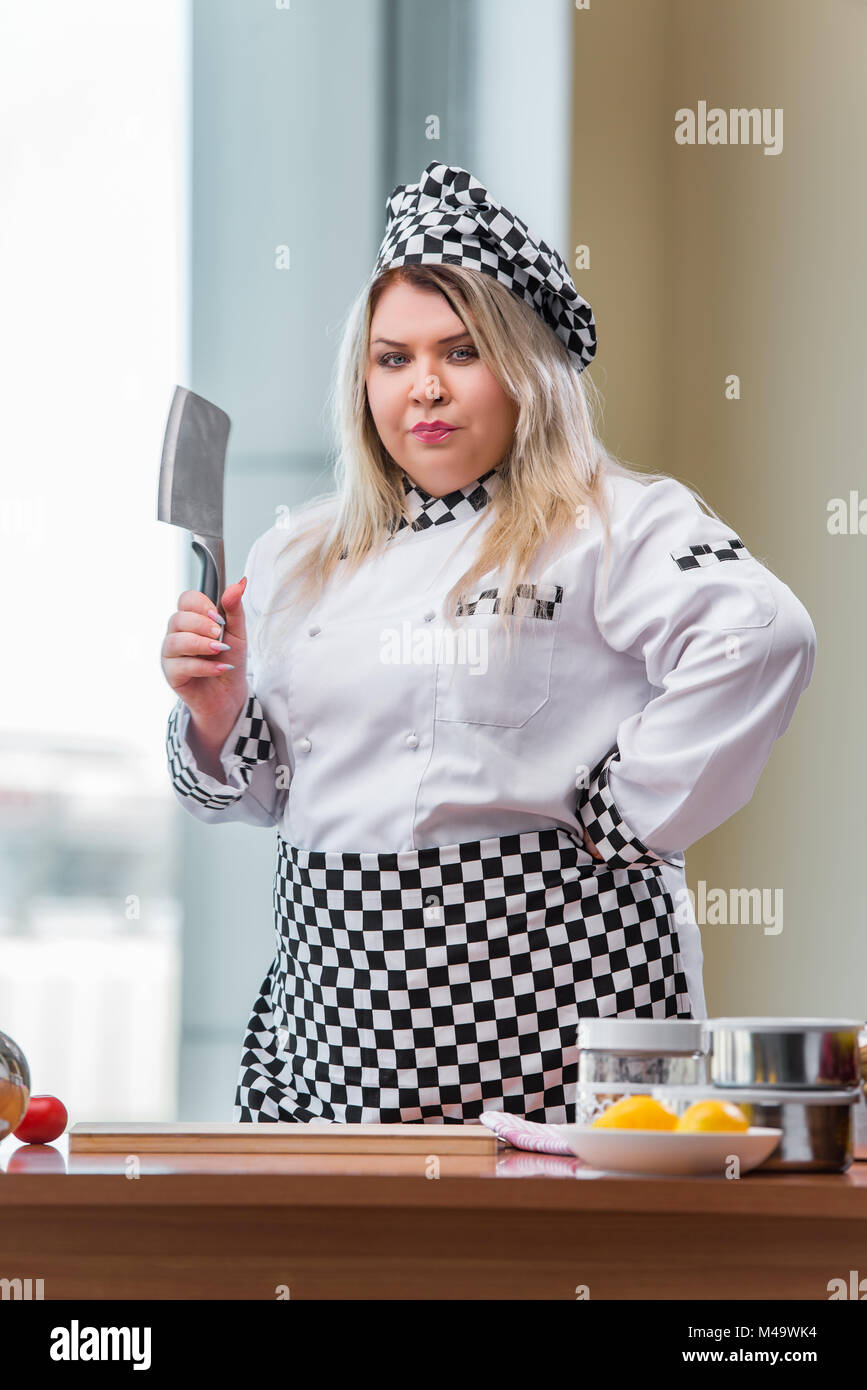 Young chef cook working in the kitchen Stock Photo - Alamy