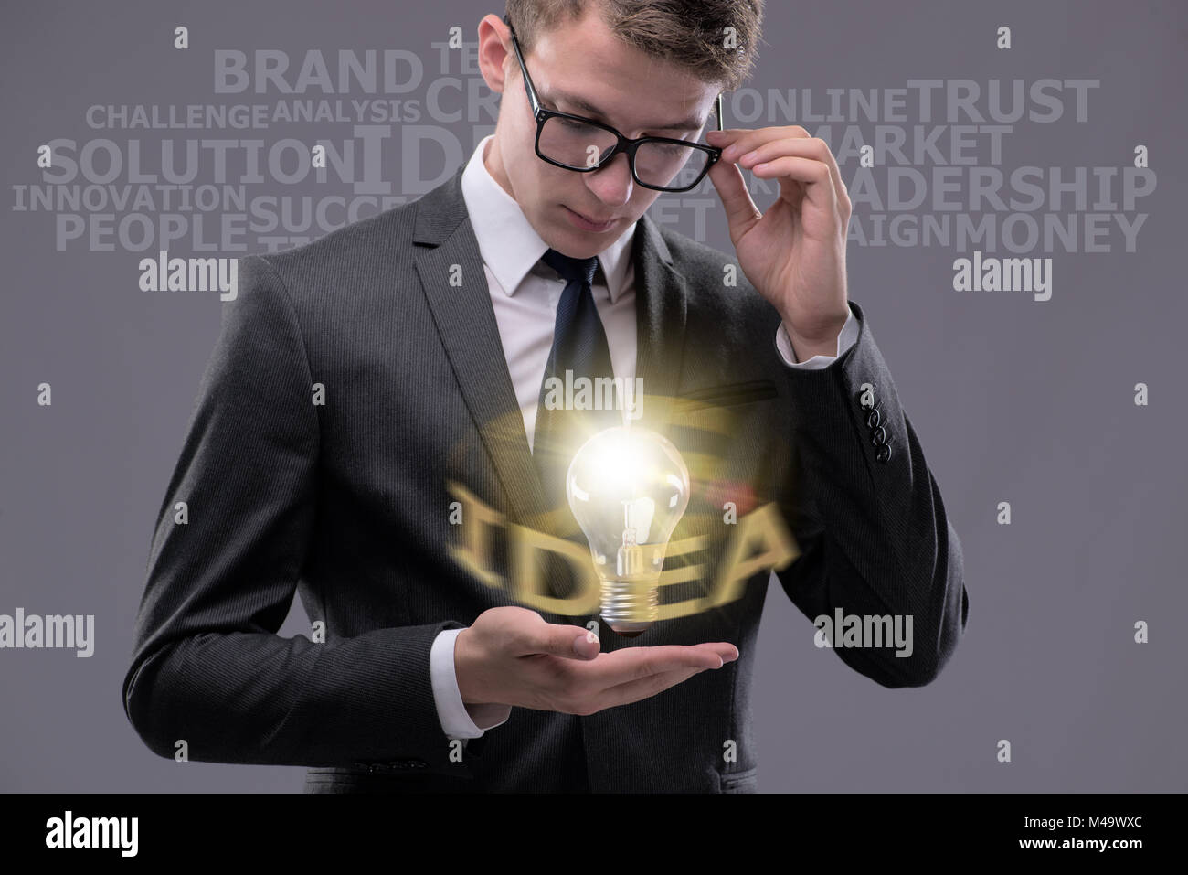 Young businessman with light bulb in idea concept Stock Photo - Alamy