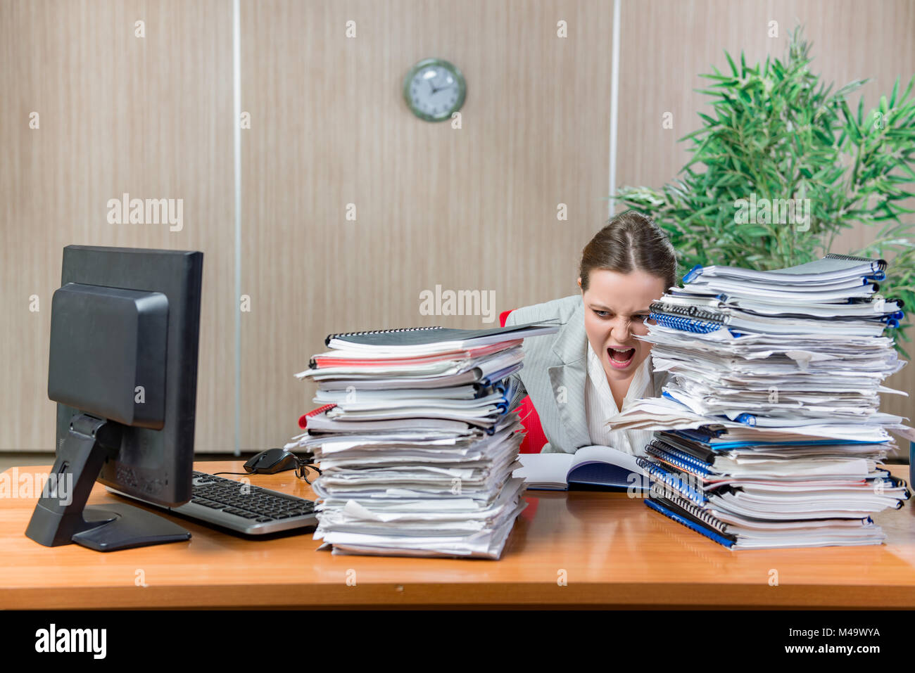 Woman under stress from excessive paper work Stock Photo - Alamy