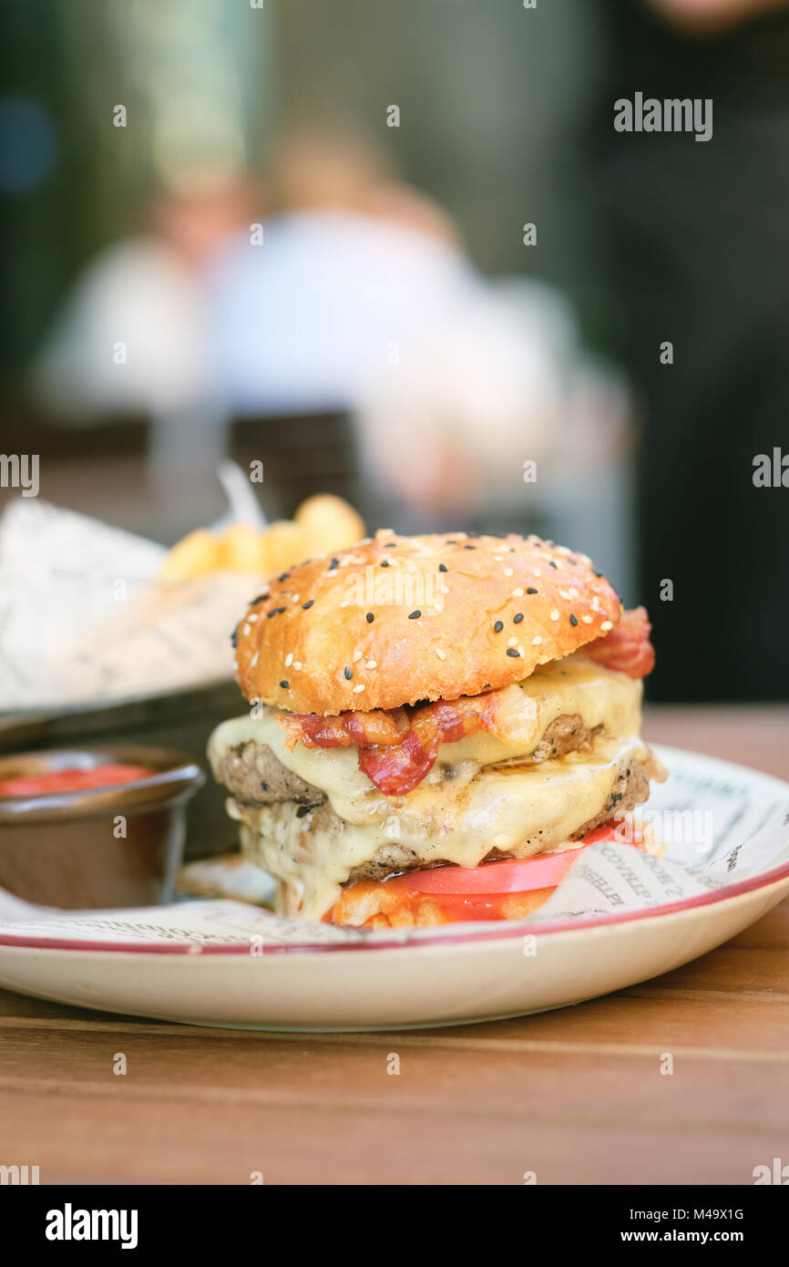 Cheeseburger in outdoor restaurant Stock Photo - Alamy