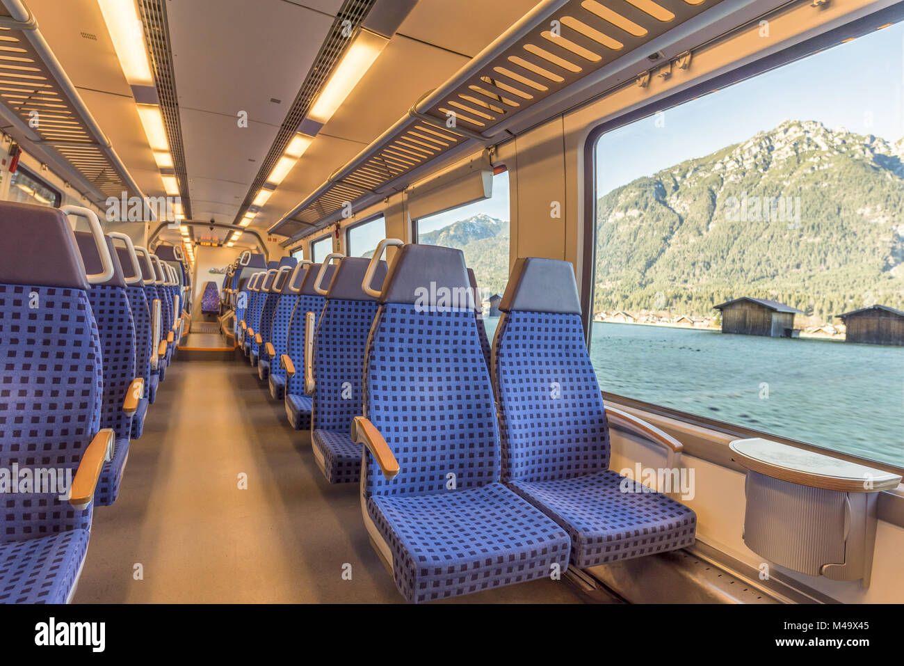 Train chairs and mountain view through the window Stock Photo - Alamy