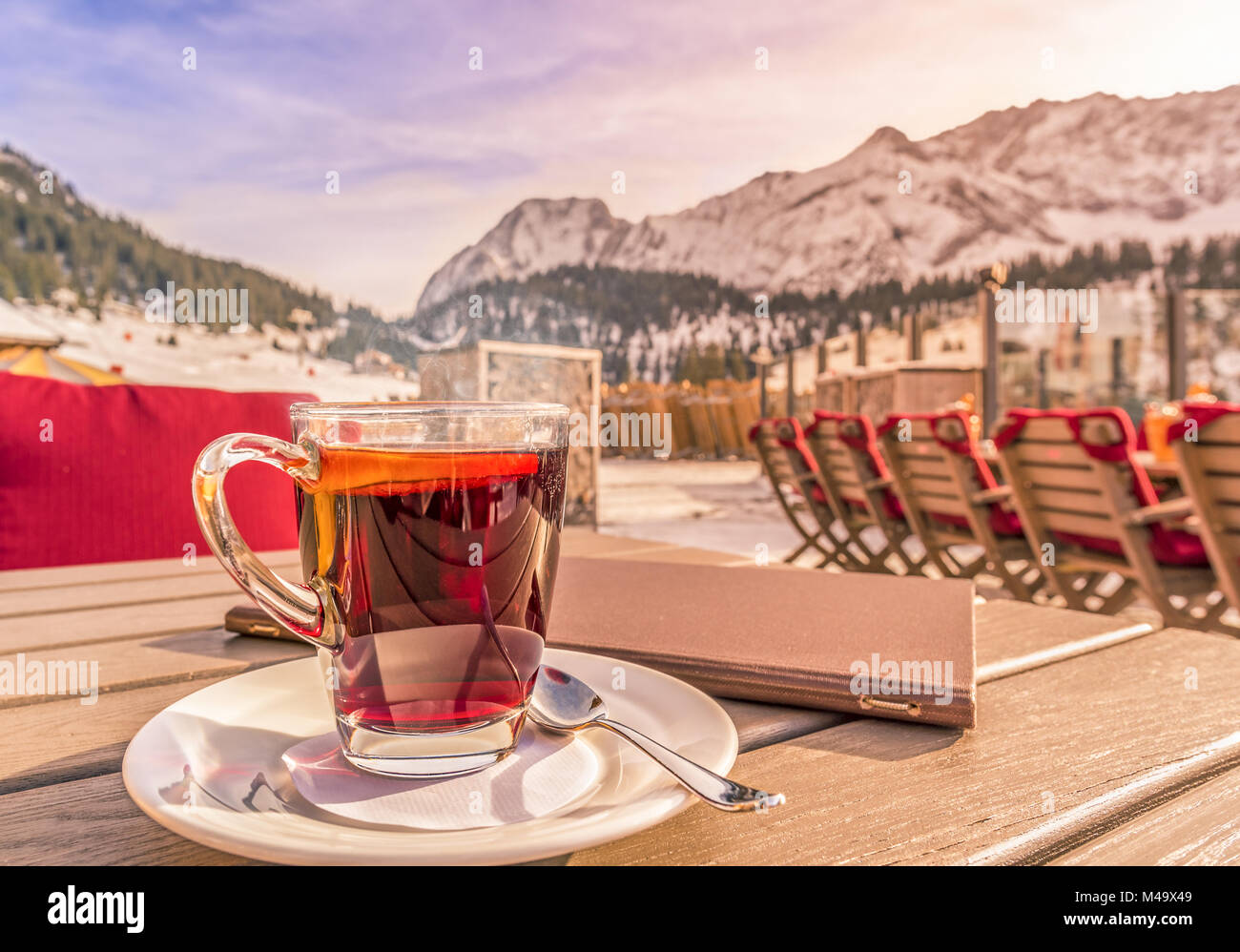Warm drink and restaurant menu on table in alpine decor Stock Photo - Alamy