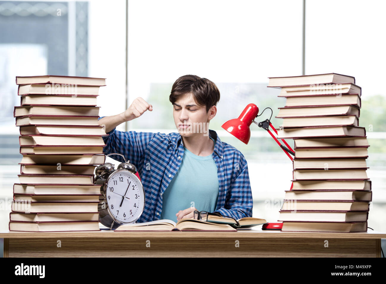 Student with lots of books preparing for exams Stock Photo - Alamy