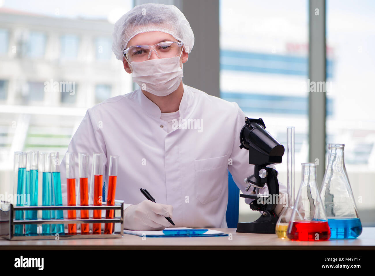 Man working in the chemical lab on science project Stock Photo - Alamy