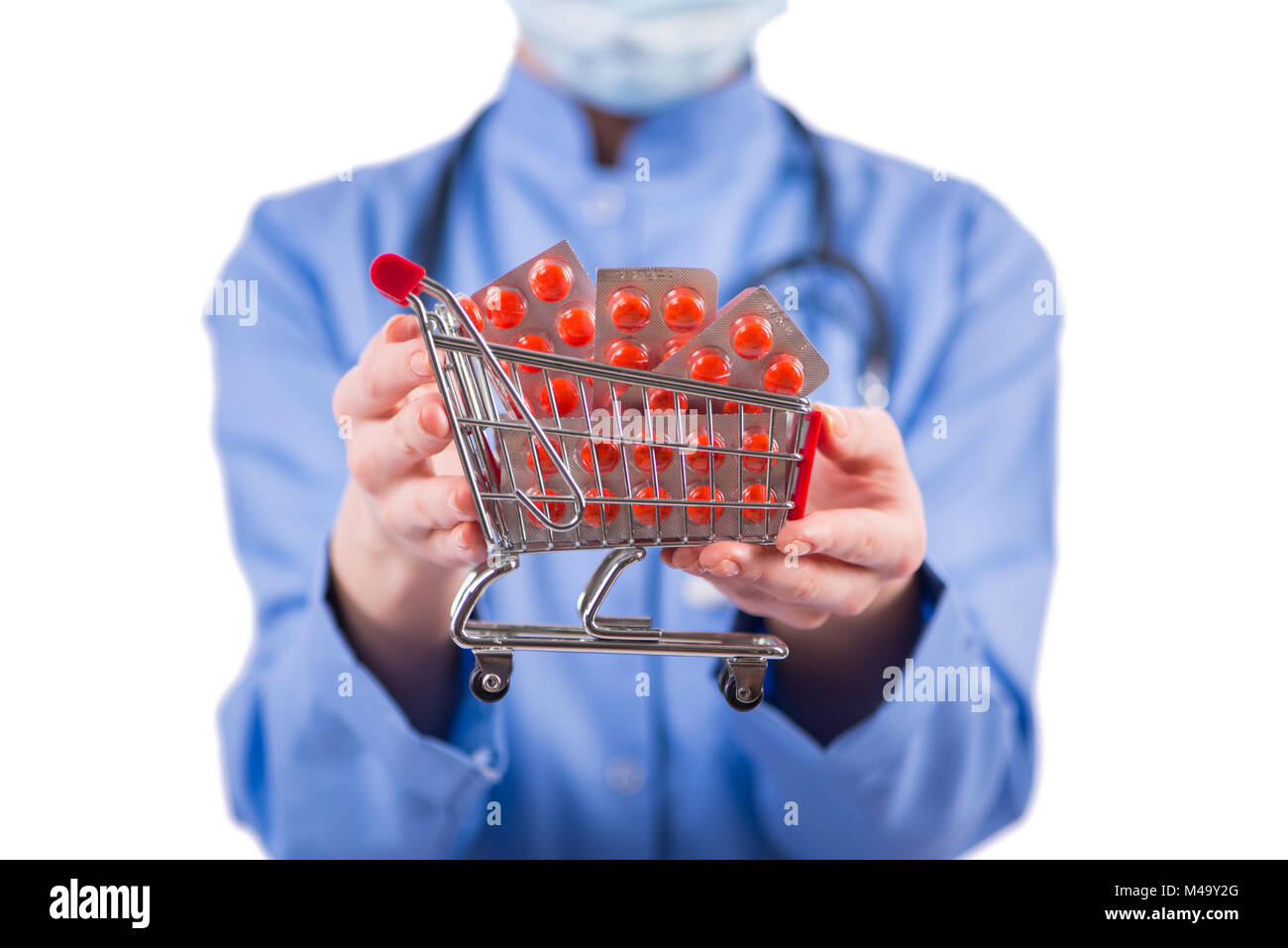Doctor with shopping cart full of pills isolated on white Stock Photo ...