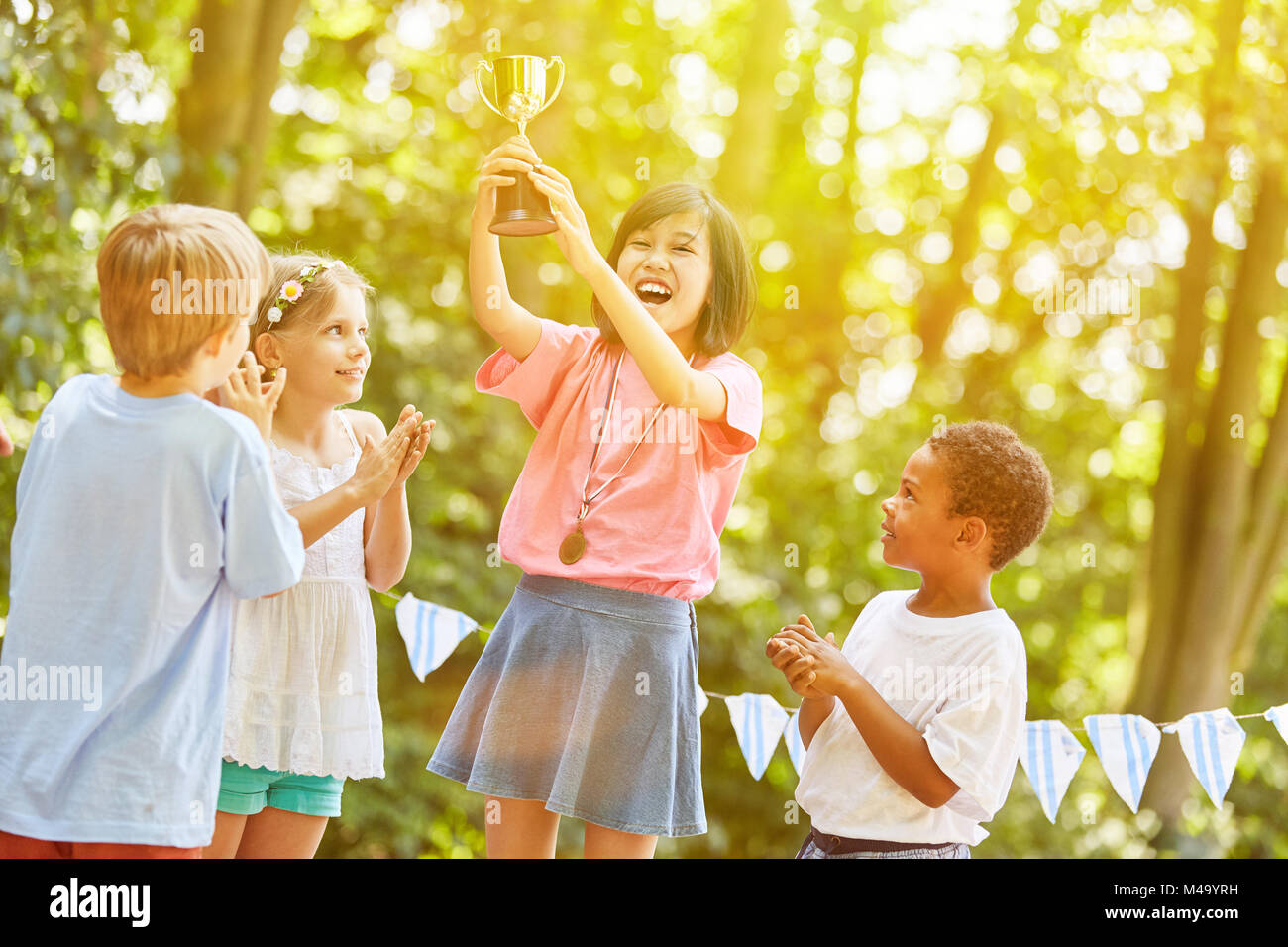Asian girl with cup cheers as winner at award ceremony in summer Stock ...