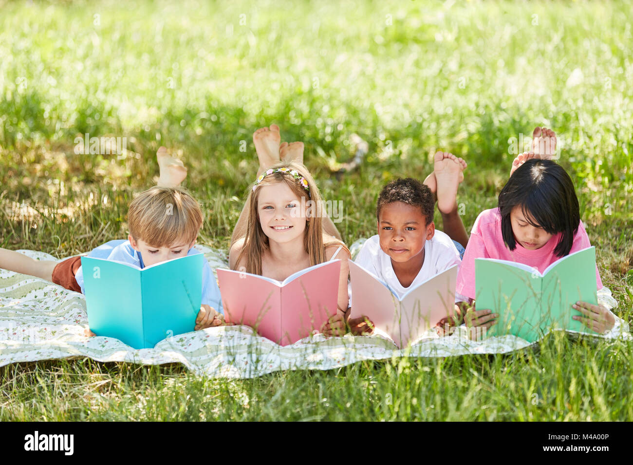 Group of primary school children learning to read in the open air Stock ...