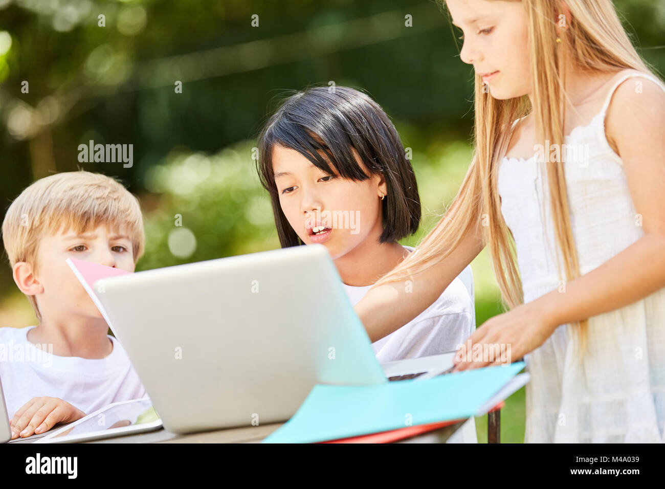 Girls learn together at the Tablet PC in the computer course of a ...