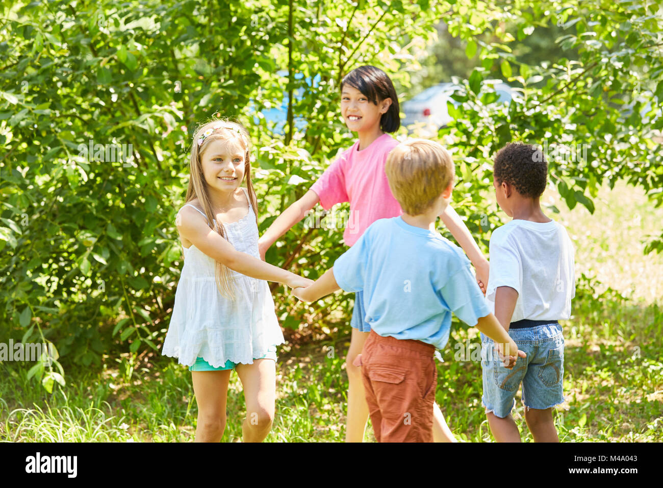 Children from the international kindergarten make a circular dance ...