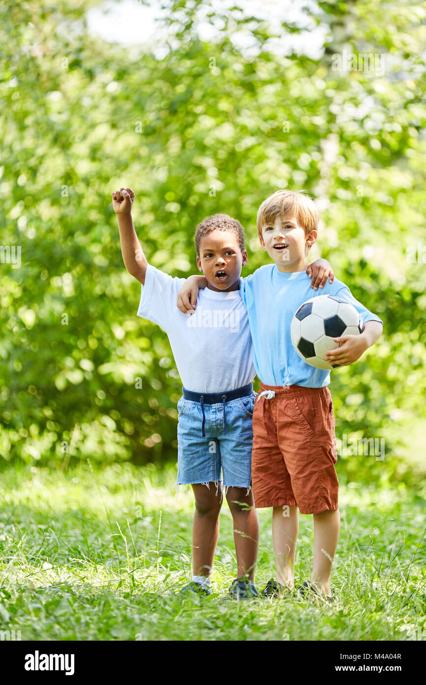 Two boys stand football hi-res stock photography and images - Alamy