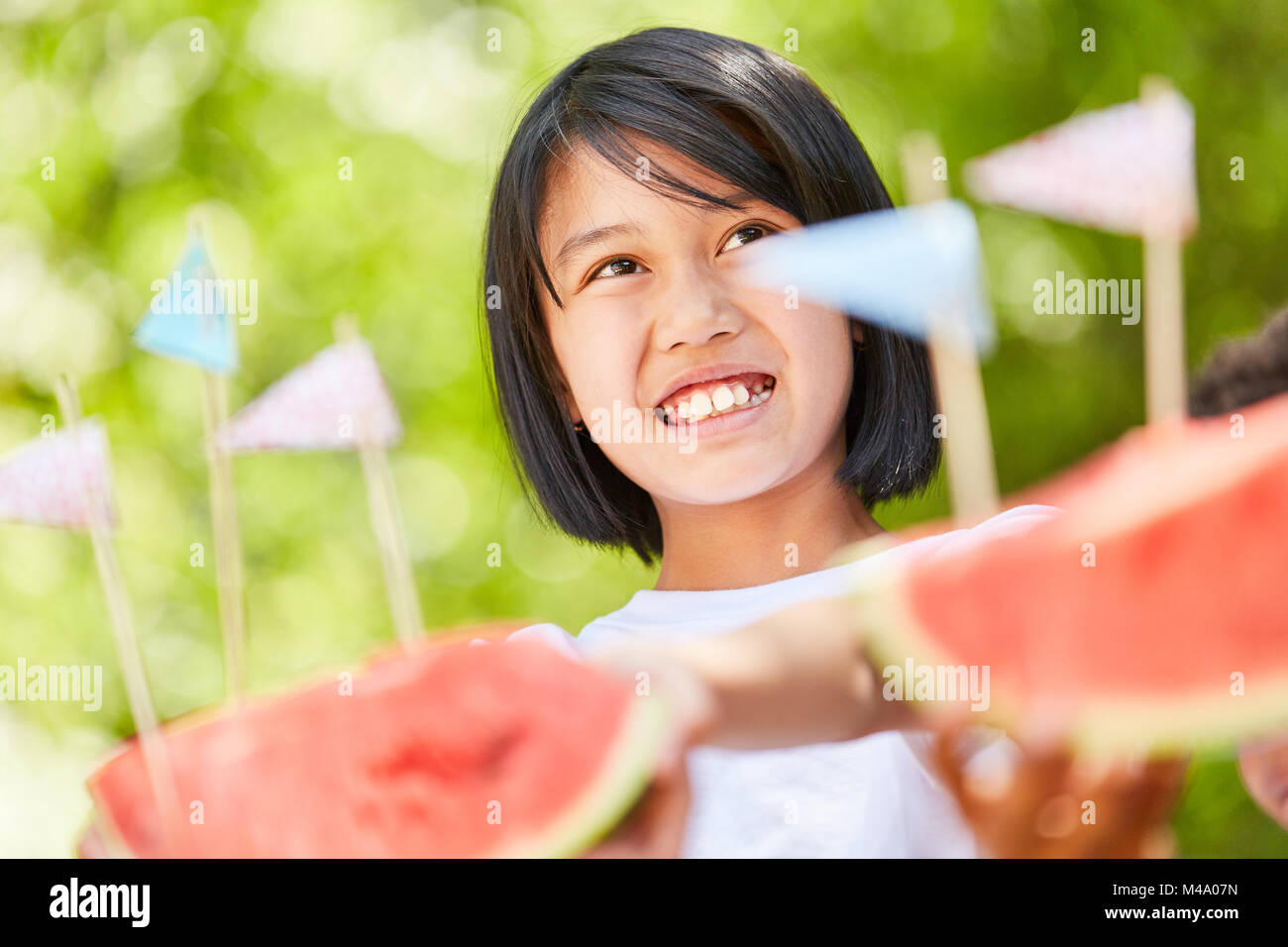 Smiling girl serves fresh and healthy watermelons as a snack Stock ...