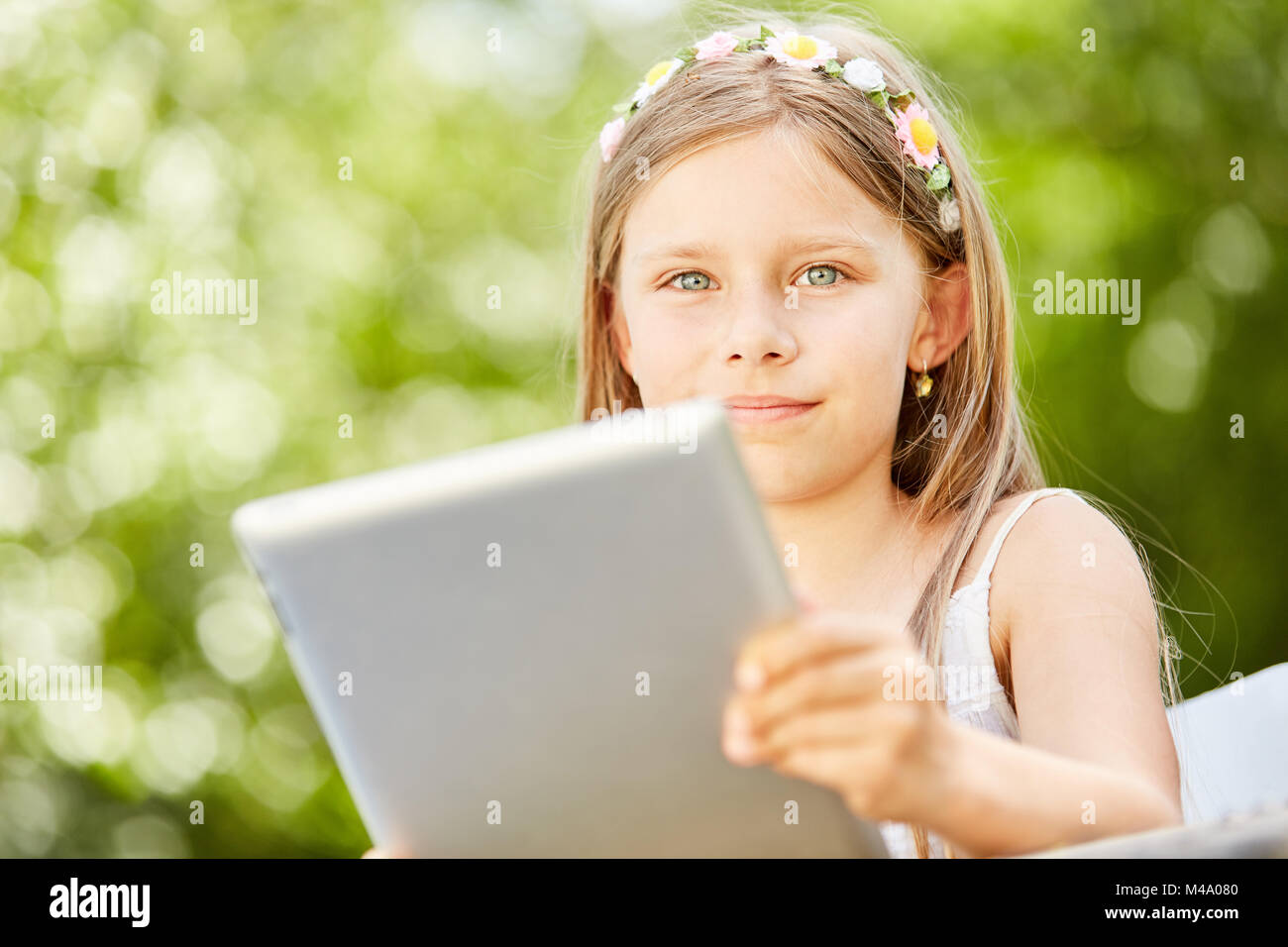 In a computer course, the girl learns how to use the Tablet PC and the ...