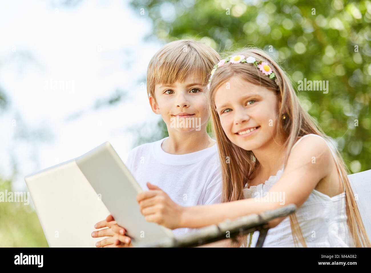 Boy and girl as friends learn how to use the tablet computer Stock ...