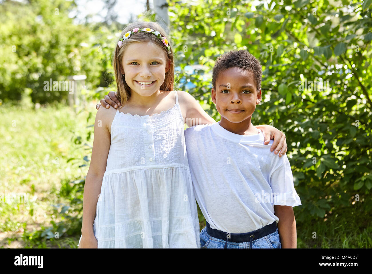 Girl and African boy as a friend and foster child side by side Stock ...