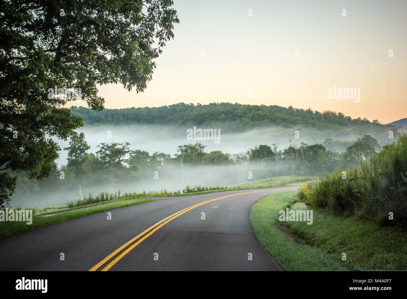 fog rolling through blue ridge parkway farm lands Stock Photo - Alamy