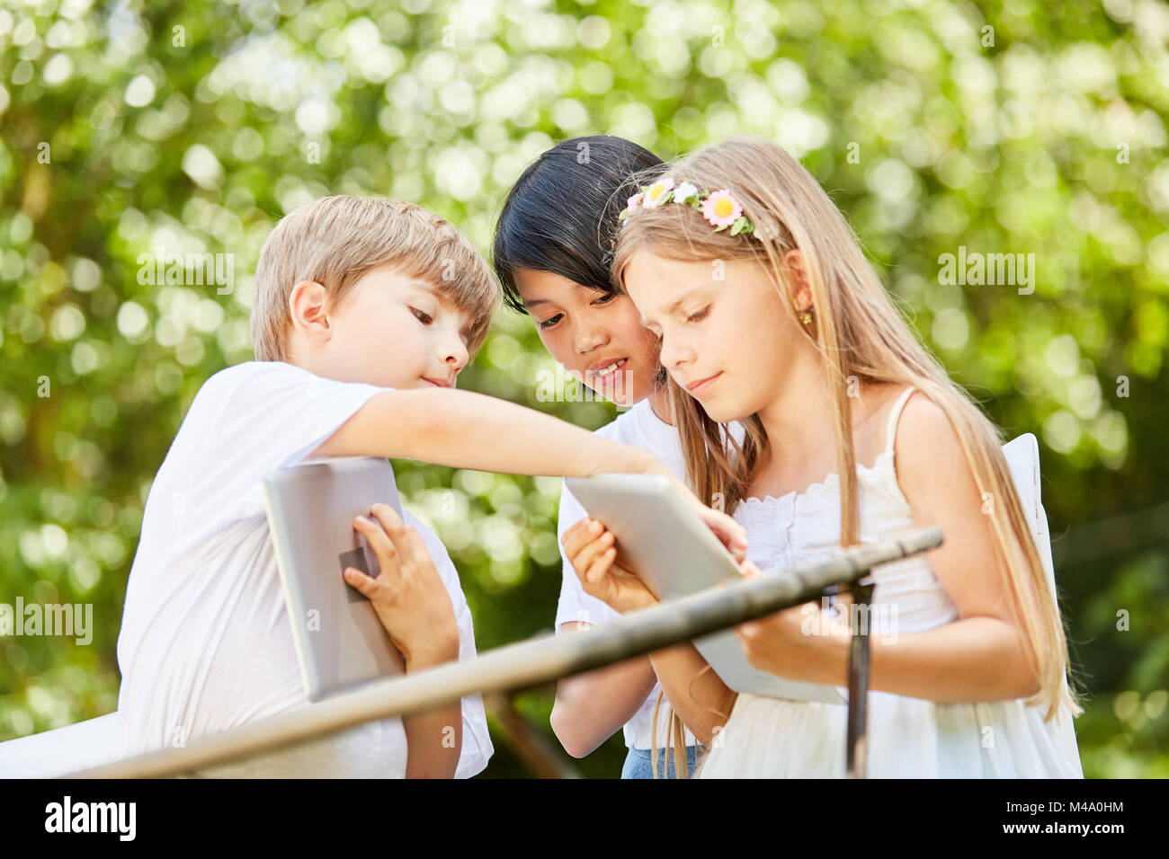 Children as students in the computer course help themselves with ...