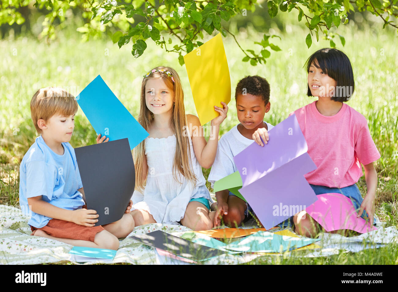 Multicultural group of children as craft group with colorful craft ...
