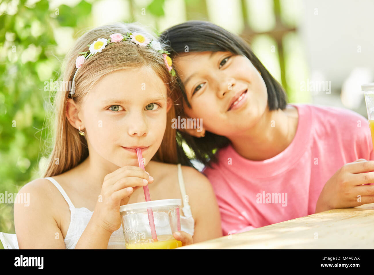 Two girls drink orange hi-res stock photography and images - Alamy